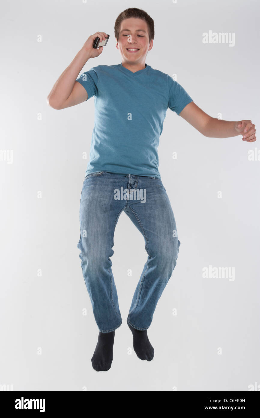 Portrait of teenage boy jumping, studio shot Stock Photo - Alamy