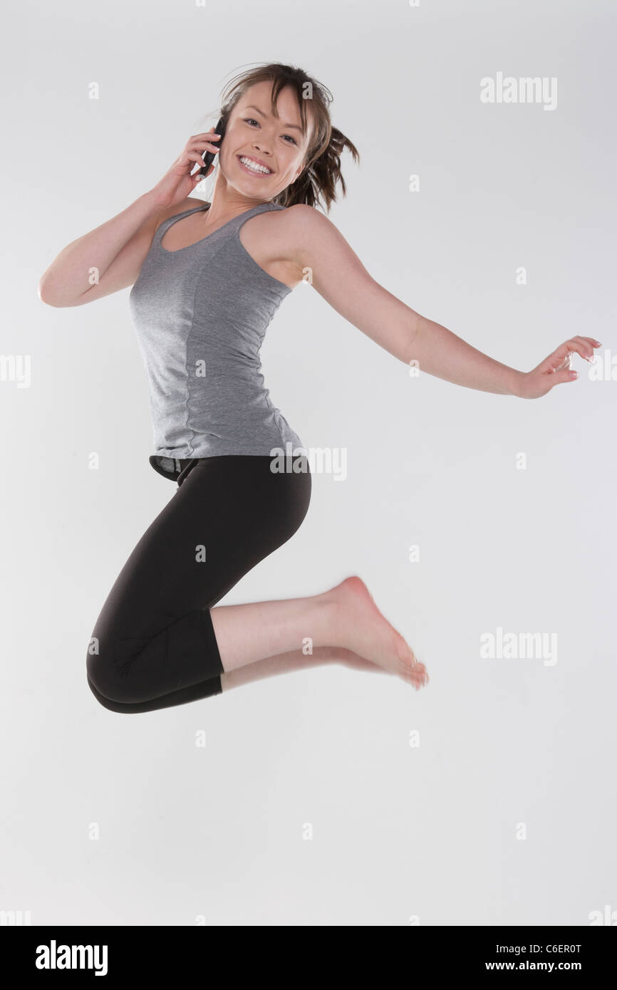 Jumping happy woman cell phone hi-res stock photography and images - Alamy