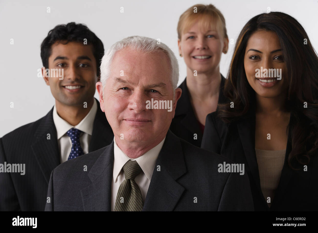 Portrait of four business people, studio shot Stock Photo - Alamy