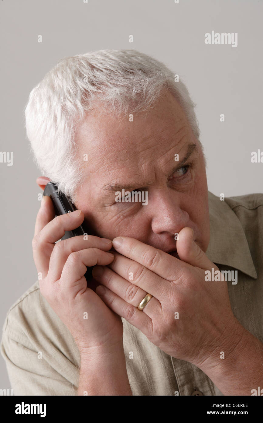 Portrait of senior man with mobile phone, studio shot Stock Photo - Alamy