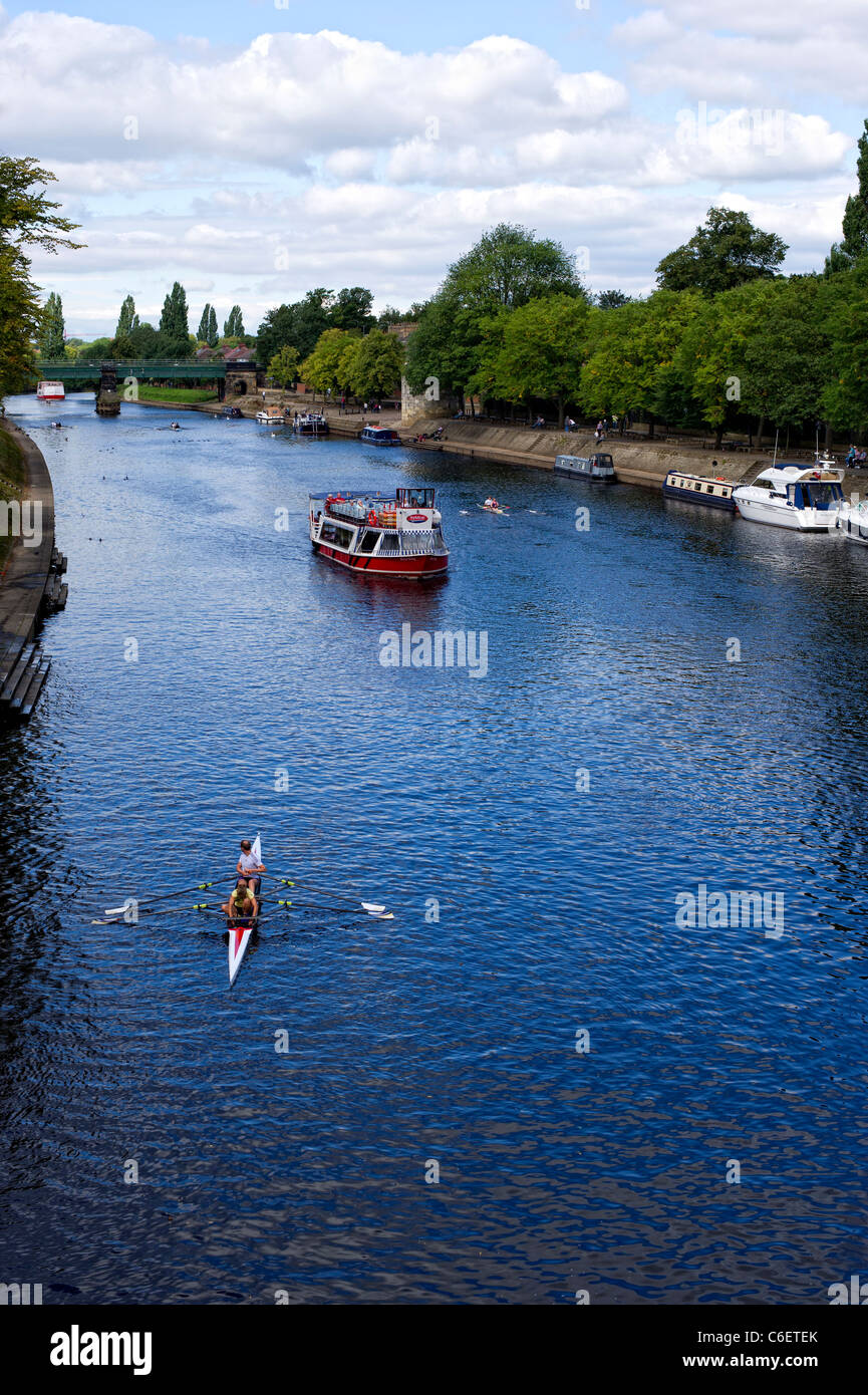 Pleasure boat and canoe on the River Ouse as it passes through the ...