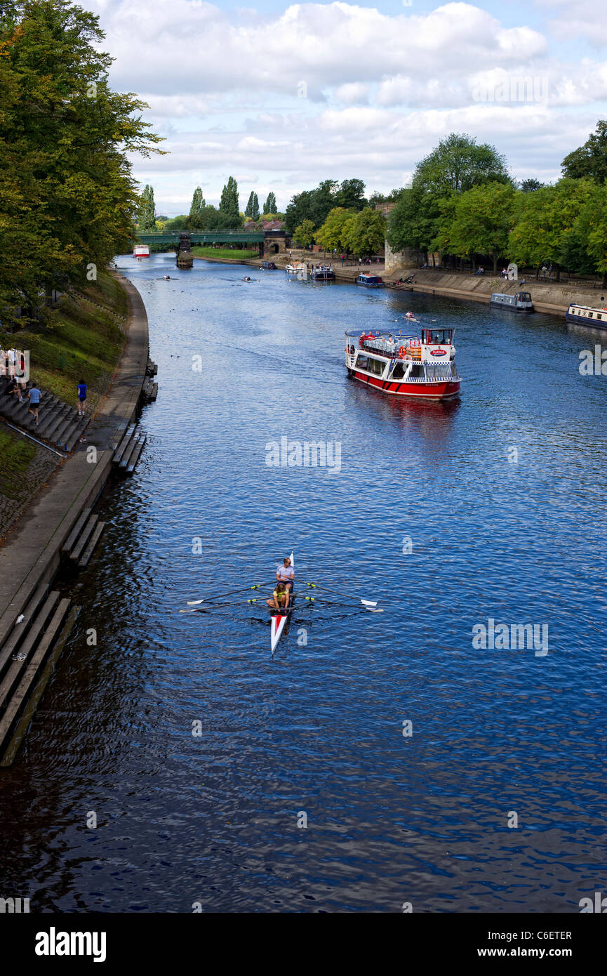 Pleasure boat and canoe on the River Ouse as it passes through the ...