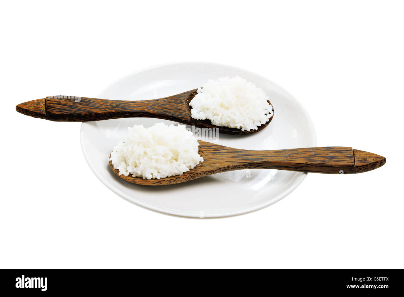 Wooden Spoons with Steamed Rice on Plate Stock Photo - Alamy
