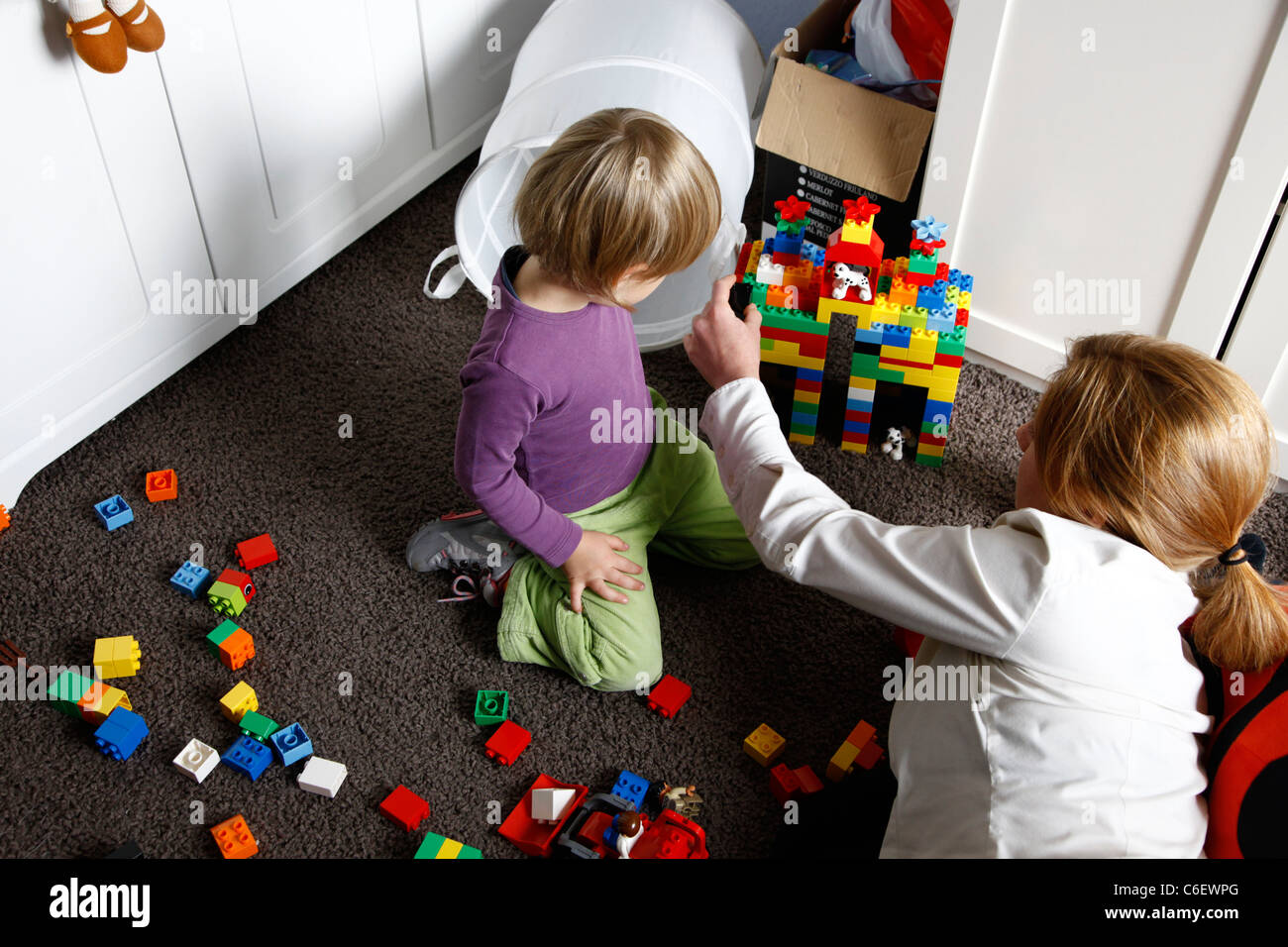 A young mother playing with Lego with her daughter Stock Photo - Alamy