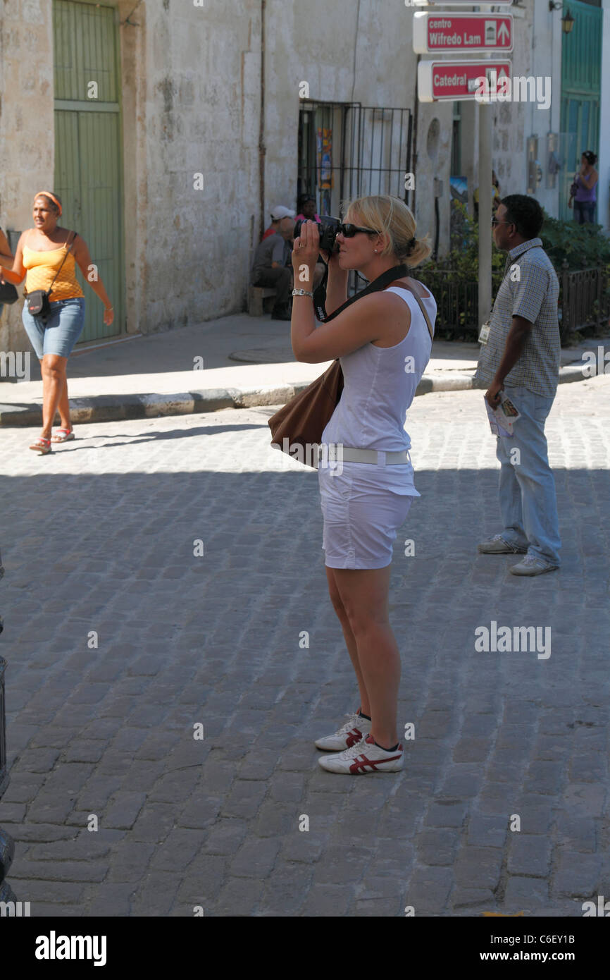 30 years old, Blond tourist woman taking photo in the street. Havana, Cuba, October 2010 Stock ...