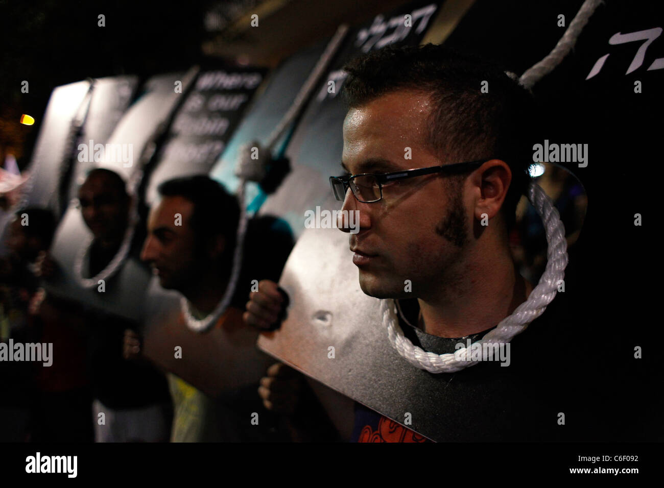 Demonstrators with rope noose around their neck part in a Social ...