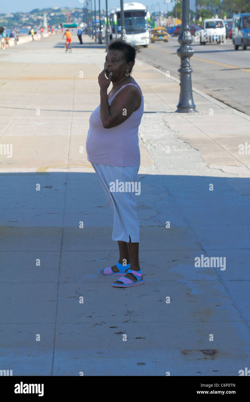 Cuban woman standing on the street at shore. Malecon, Havana, Cuba, October 2010 Stock Photo - Alamy