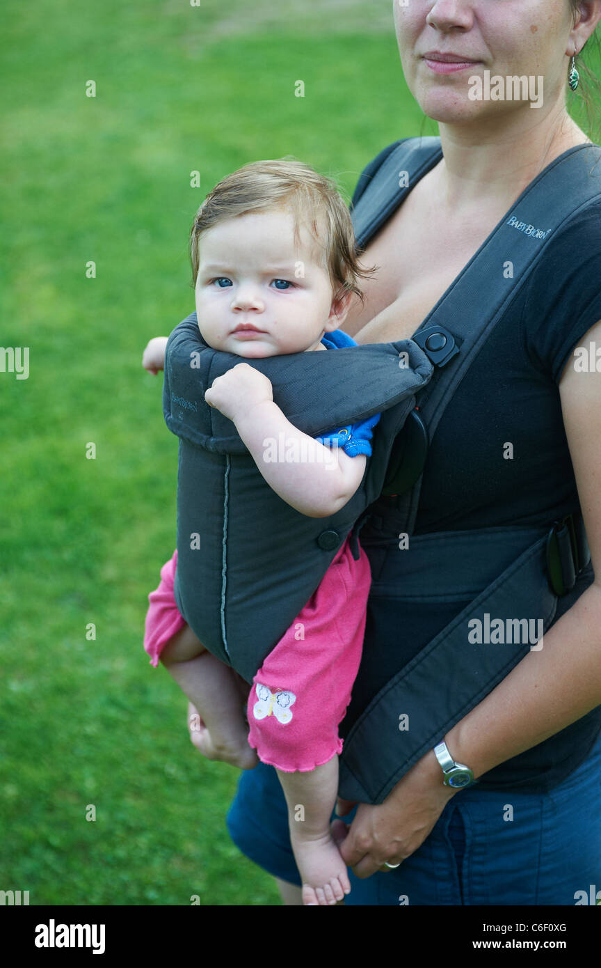 Mother carrying baby in baby carrier outside Stock Photo - Alamy