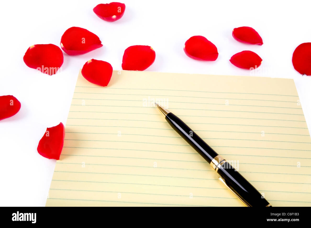 red rose petals and letter paper in white background, love concept ...