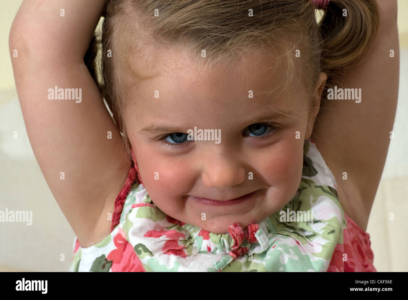 young toddlers girl smile smiling cute arms raised Stock Photo - Alamy