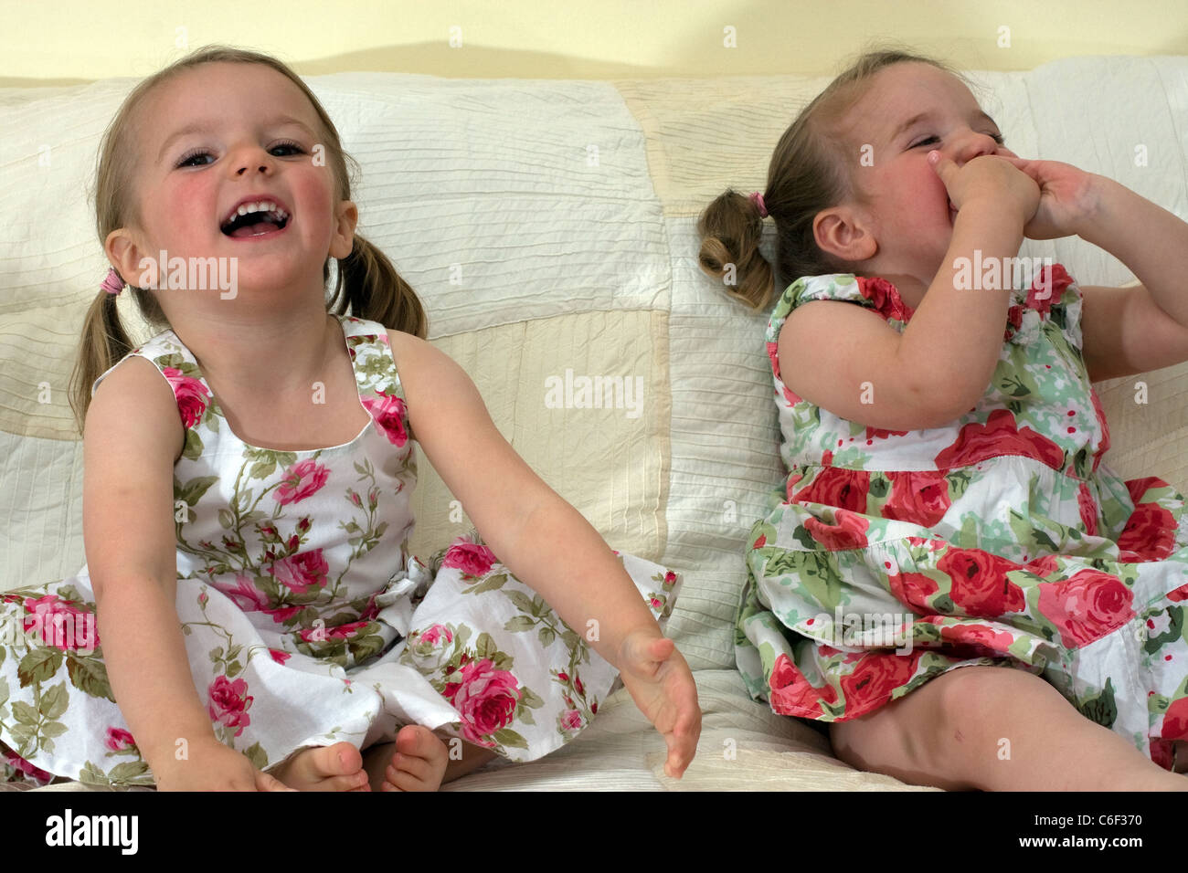 young toddlers girl smile smiling twins happy Stock Photo - Alamy