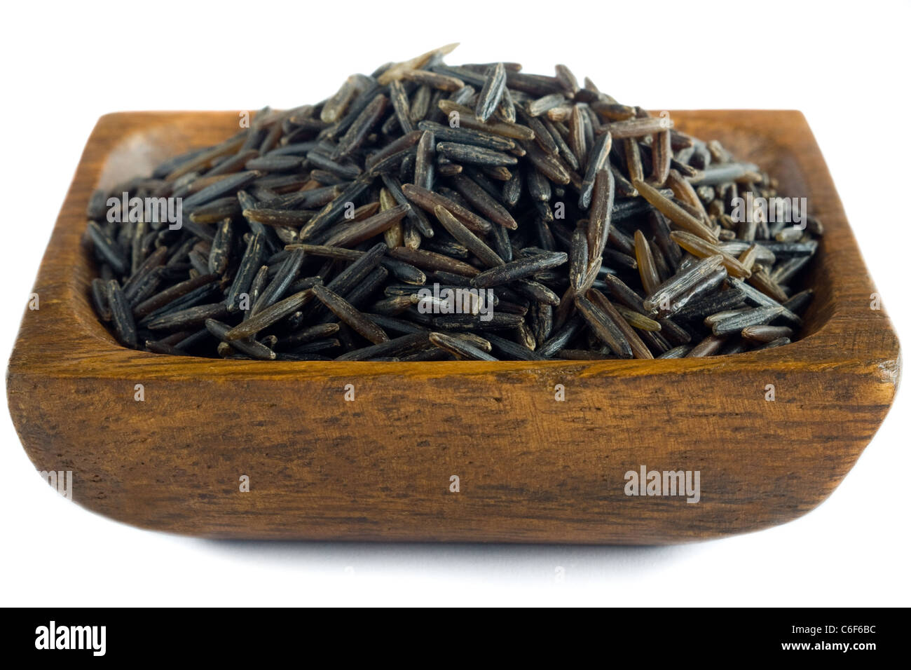 Wild rice in wooden bowl isolated on white background Stock Photo - Alamy