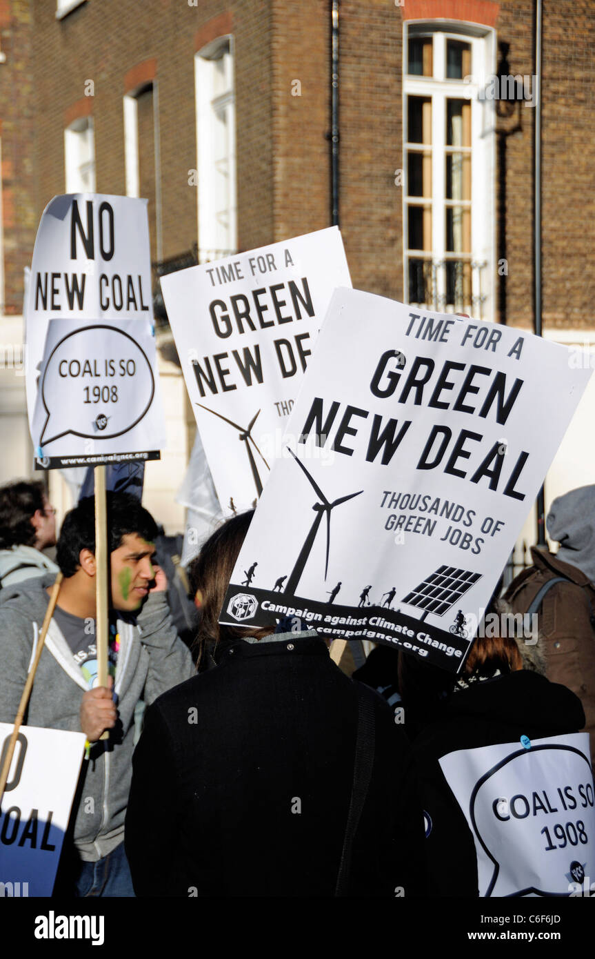 People holding banners saying Green New Deal on Climate Change March ...