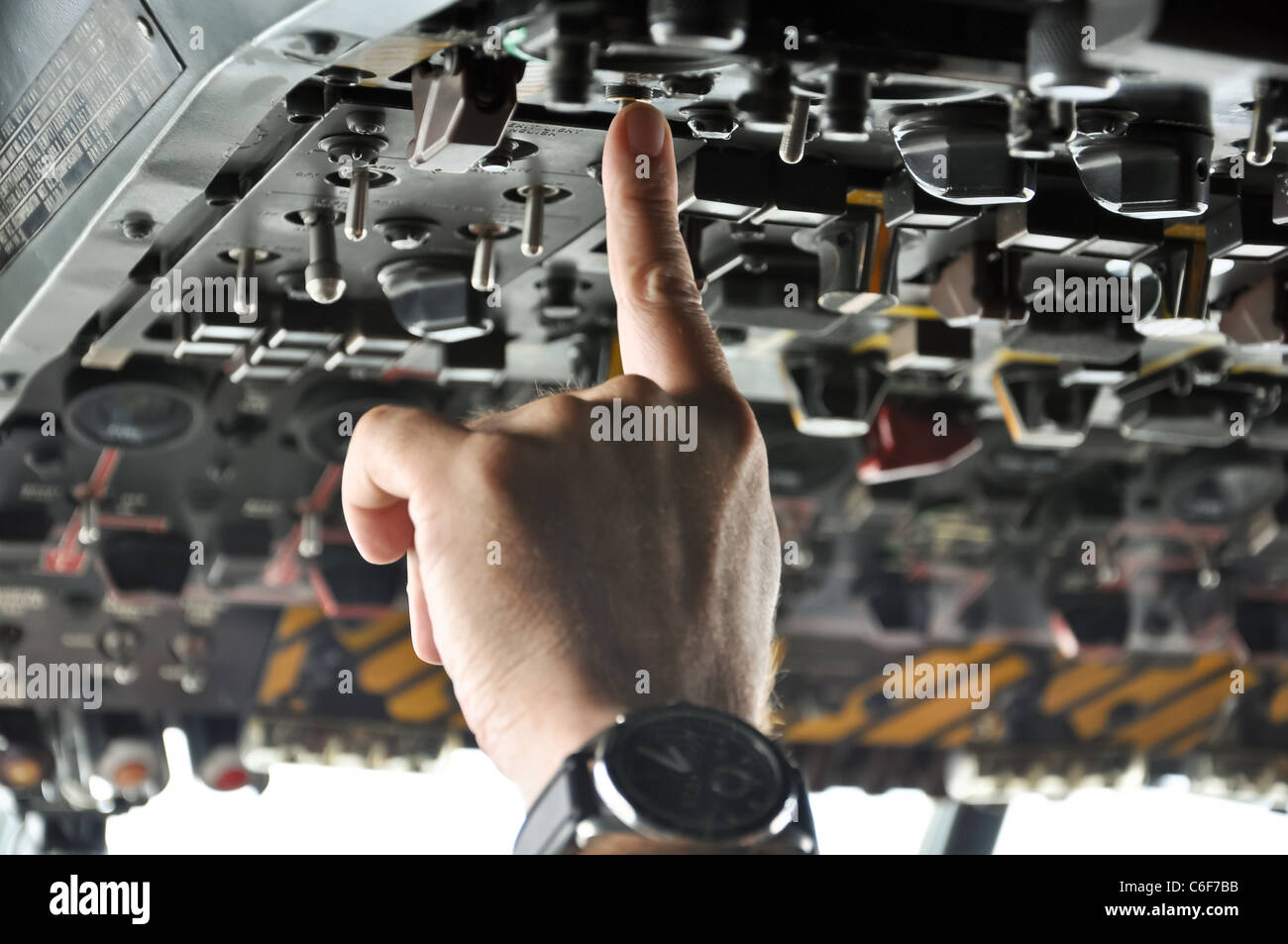finger of a pilot pushing buttons in an airplane cockpit Stock Photo ...