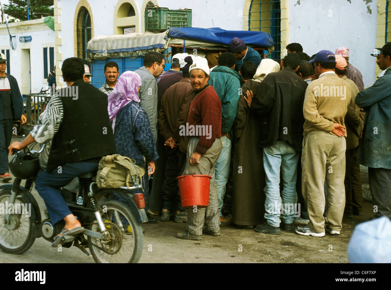 Crowd gathers as the fishermen's catch is landed at Essaouira, Morocco ...