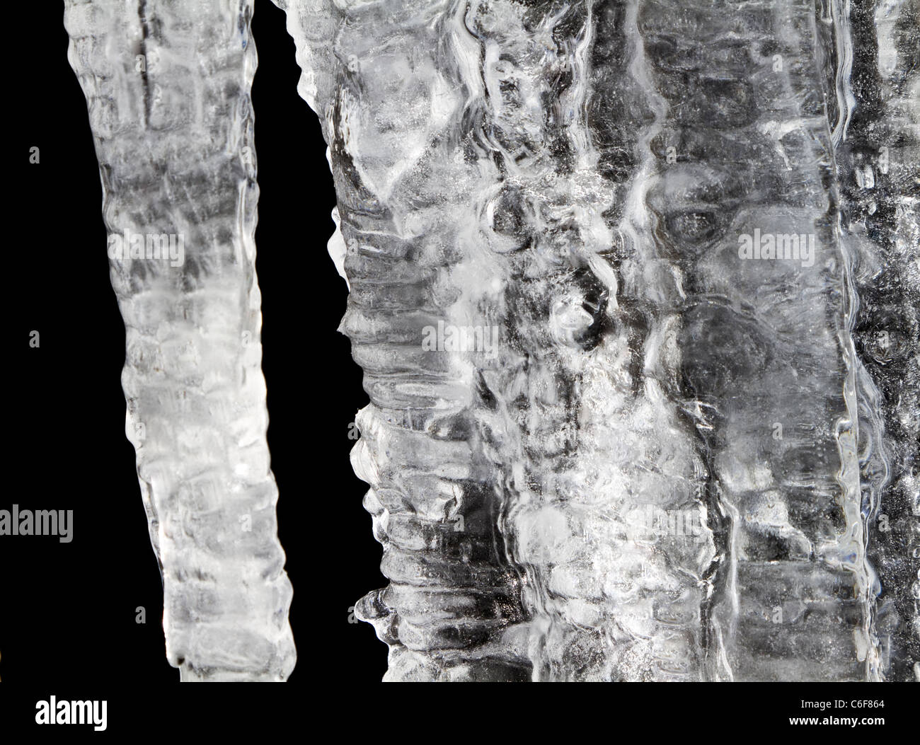 Close up of glistening icicles, light painted for effect, in winter ...