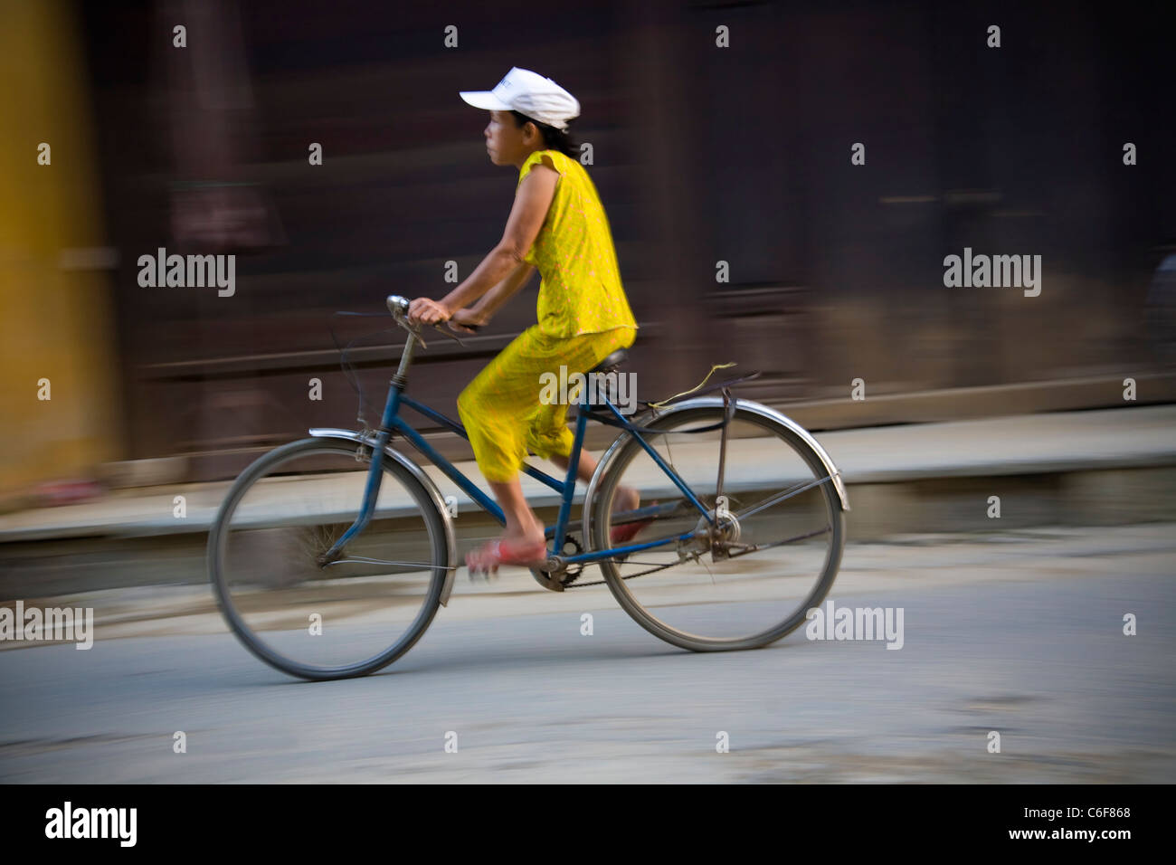 Boy cycling in Hoi An, Vietnam Stock Photo - Alamy