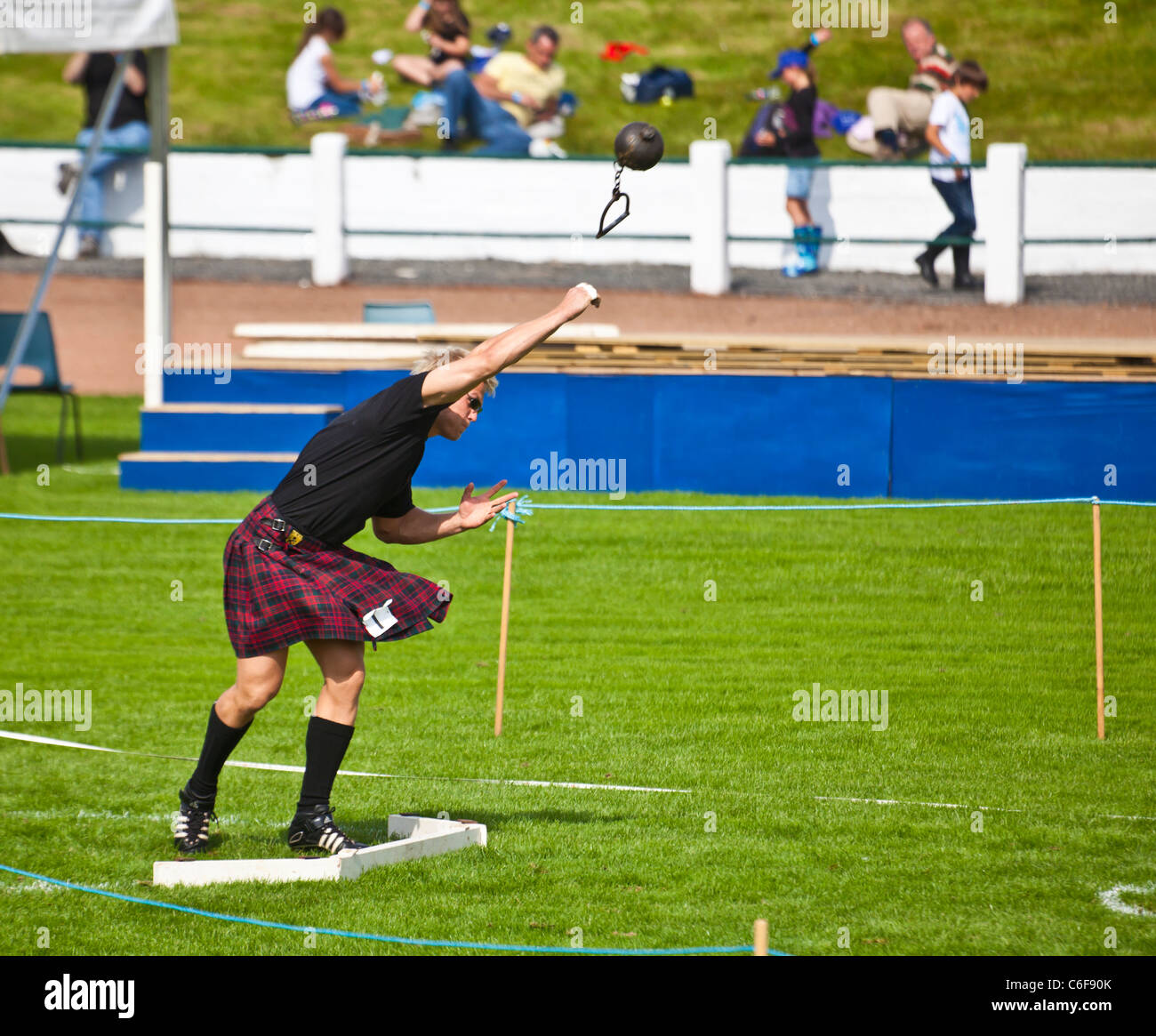 Kilted German athlete throwing a hammer while competing in the Heavy ...