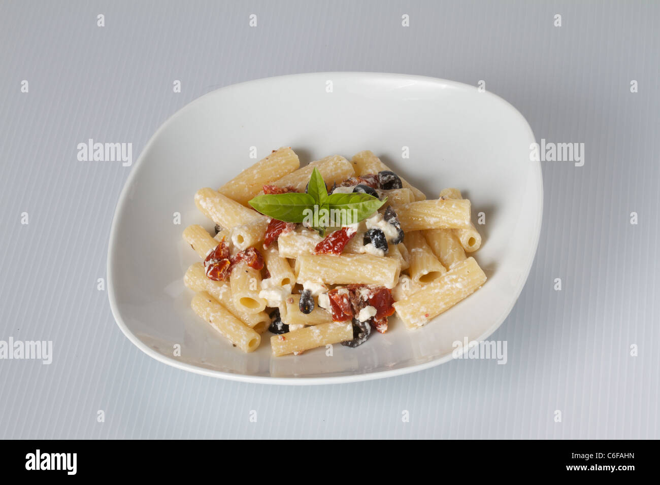 maccheroni with feta cheese,basil and tomatoes Stock Photo - Alamy