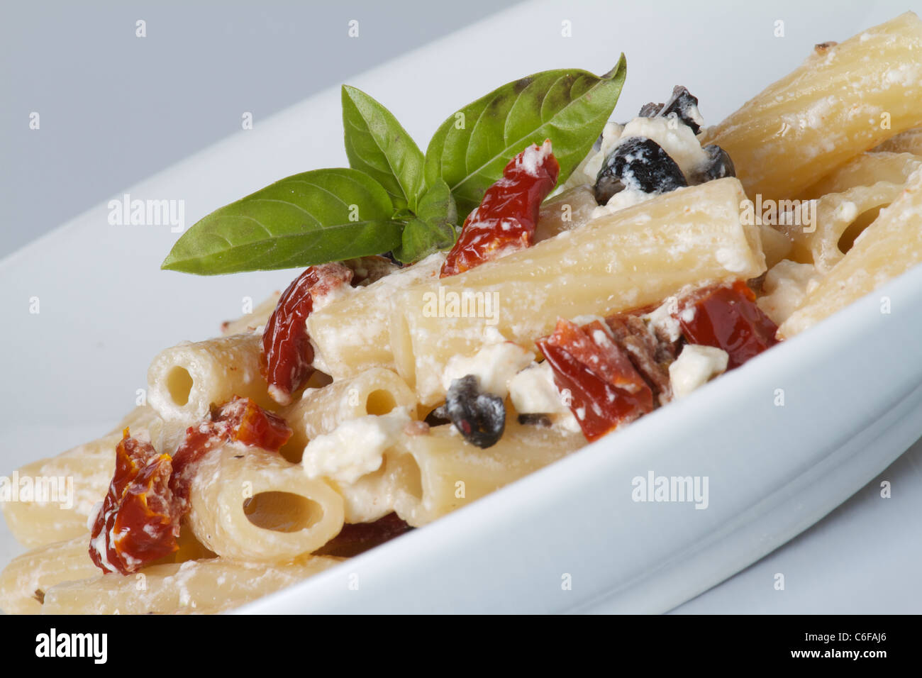 maccheroni with feta cheese,basil and tomatoes Stock Photo - Alamy
