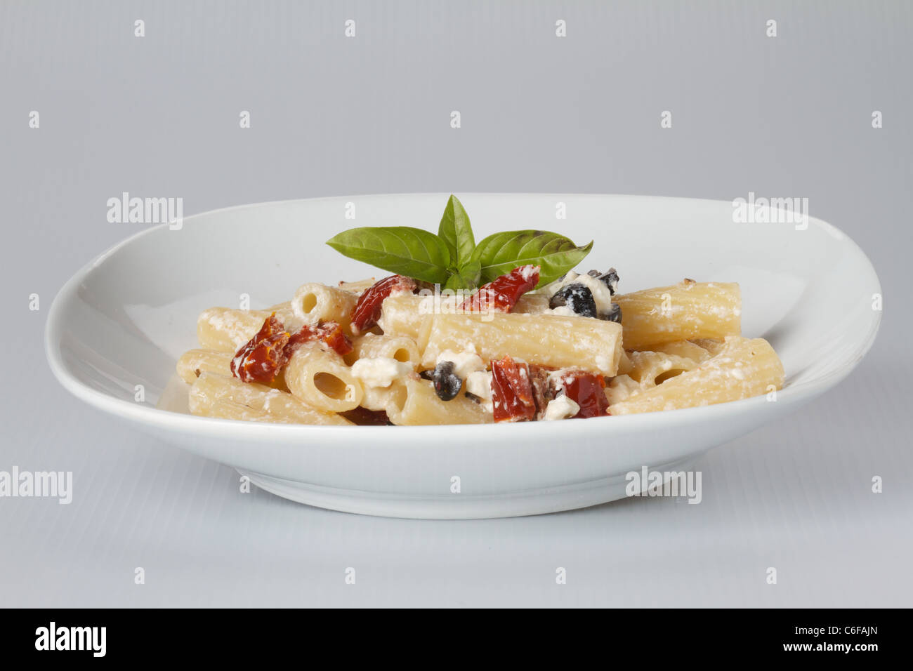 maccheroni with feta cheese,basil and tomatoes Stock Photo - Alamy