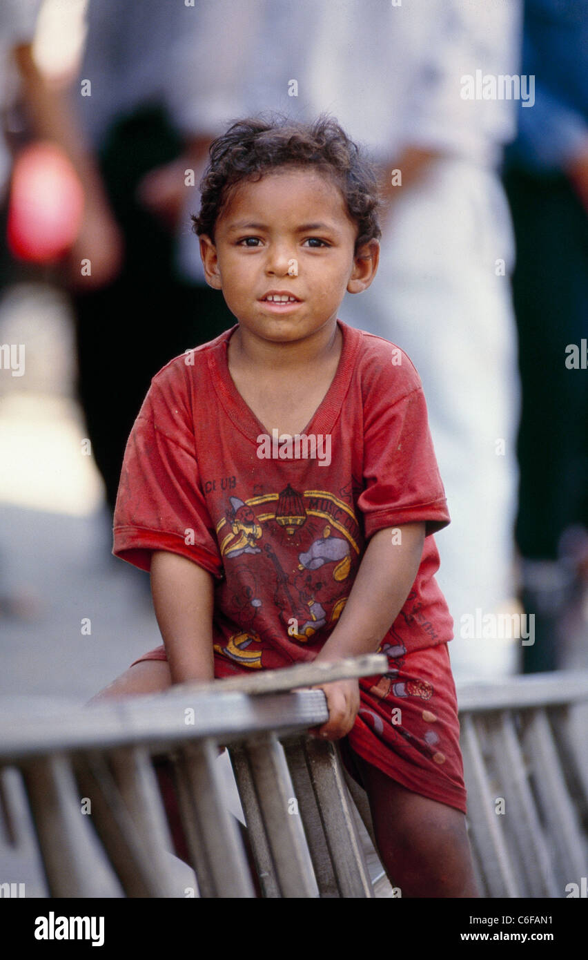 An inner city Egyptian boy in Cairo plays on a ladder Stock Photo - Alamy