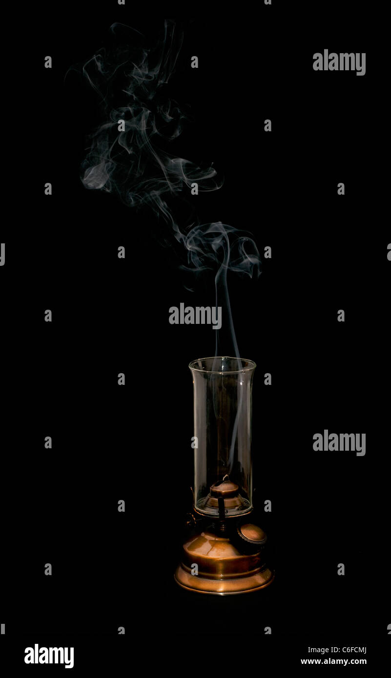extinct oil lamp and smoke on black Stock Photo - Alamy