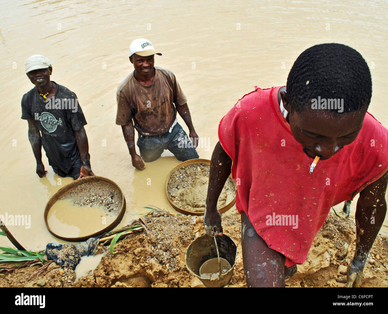 Diamond miner smokes a cigarette by a mine in Kono, Sierra Leone, West ...