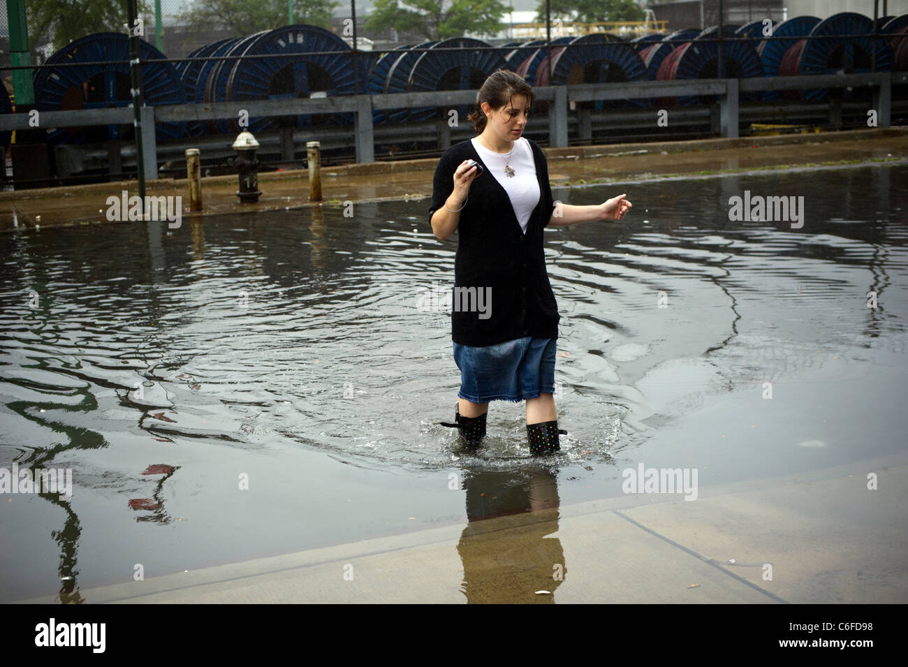 Woman wades through flooding on Twelfth Avenue in the Chelsea ...
