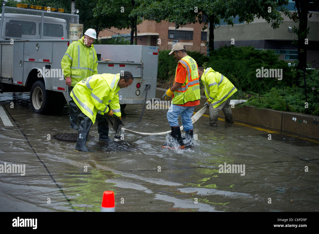 Department of Environmental Protection workers drain flooding along ...