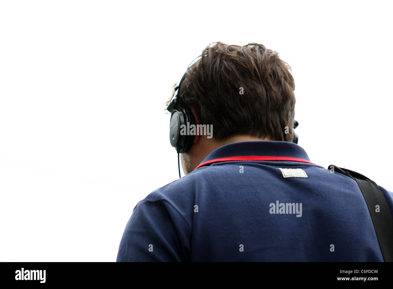 Looking up at the rear of a male wearing headphones Stock Photo - Alamy