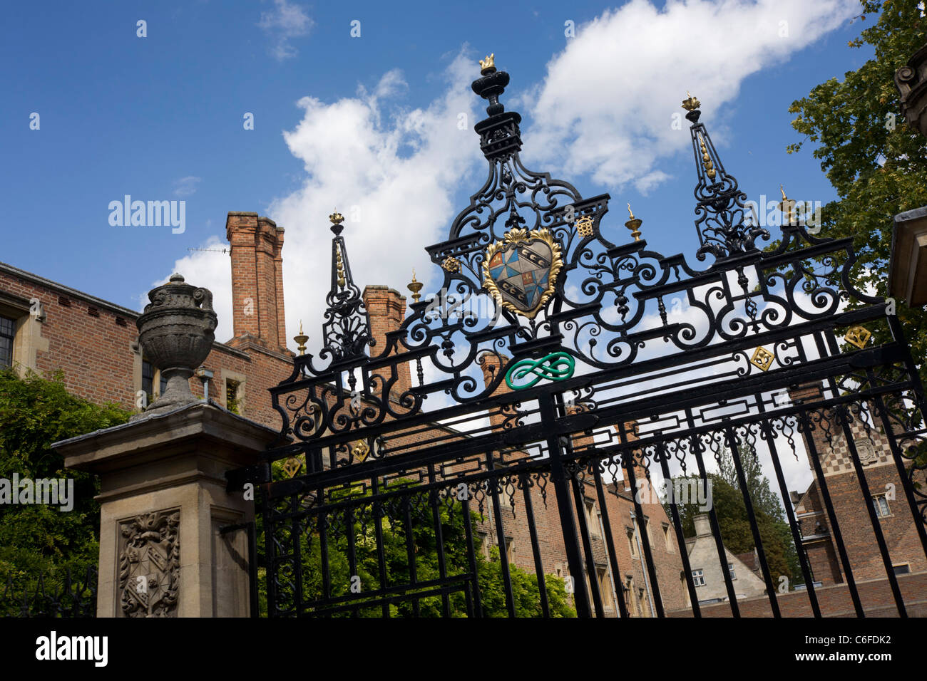 Looking up at the tall wrought iron gates of Magdalene College, a ...