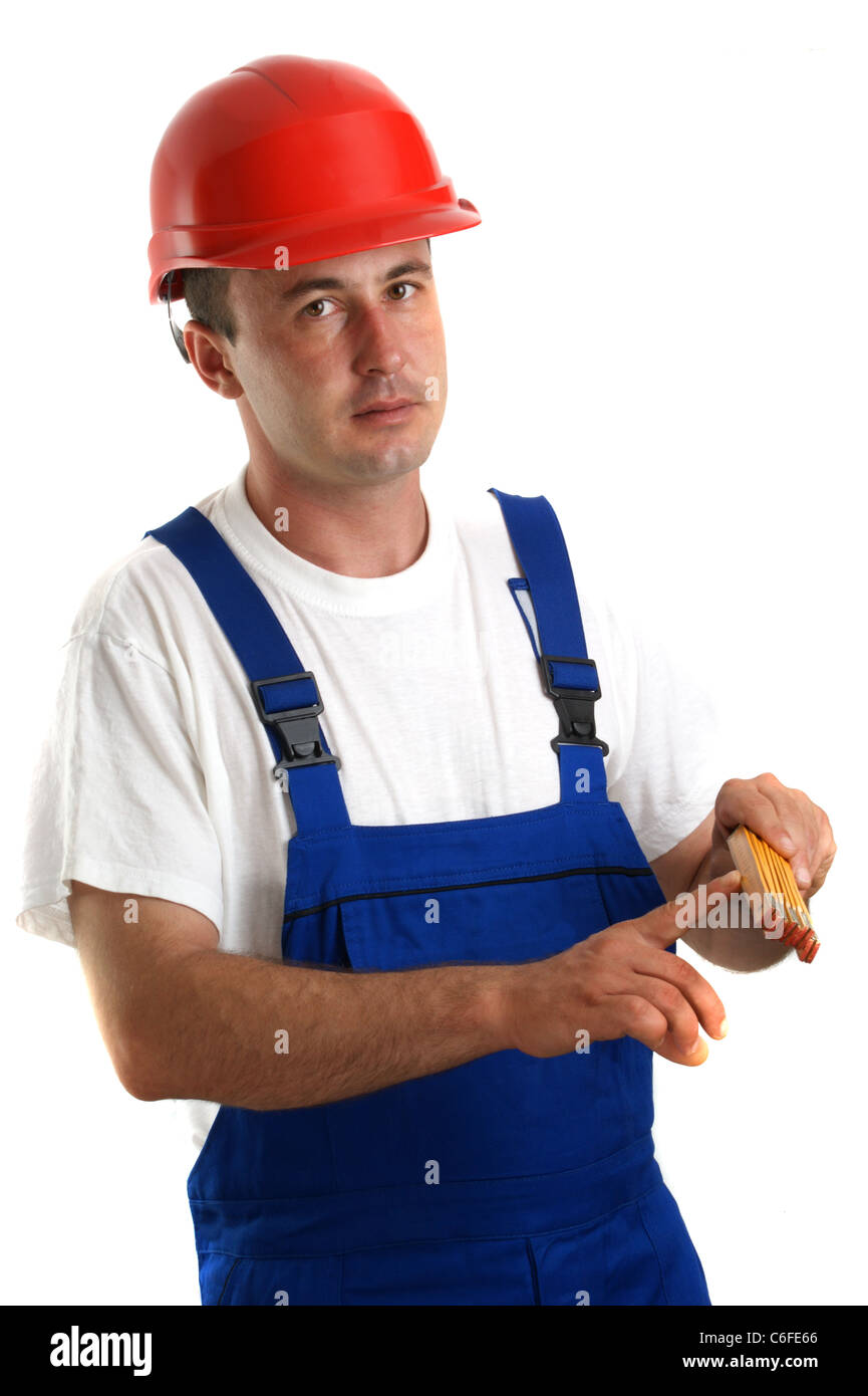 young craftsmen in work clothes holding a ruler Stock Photo - Alamy