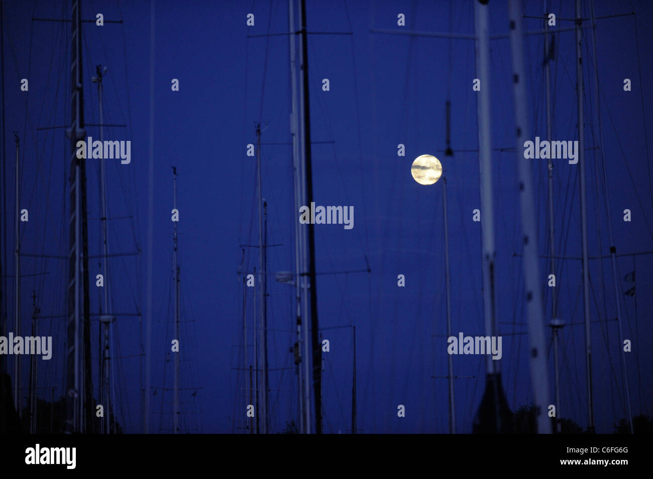 Sailing boats in a harbour at full moon Stock Photo - Alamy