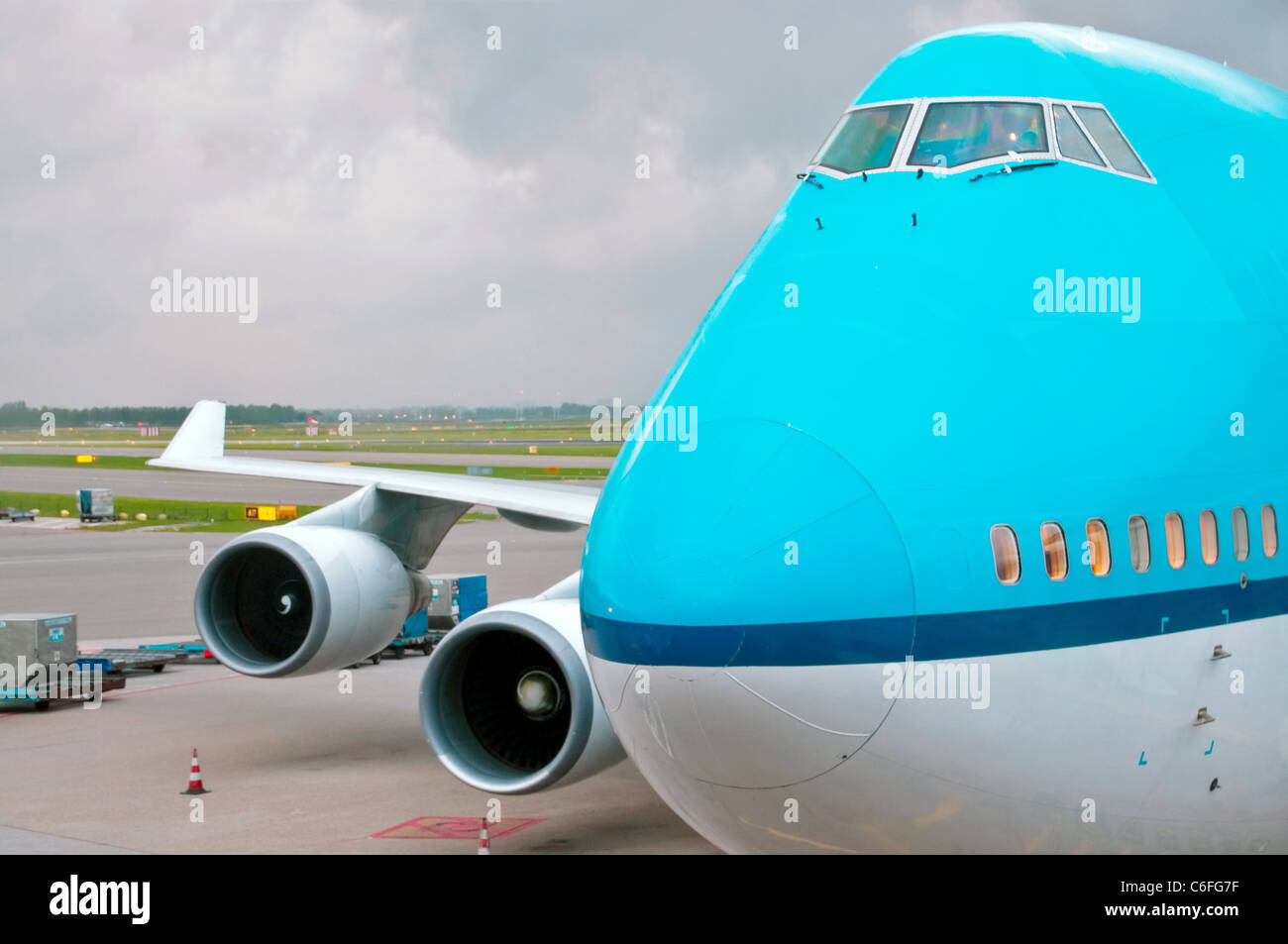 Azure jet airplane landed in a airport with bad wather Stock Photo - Alamy