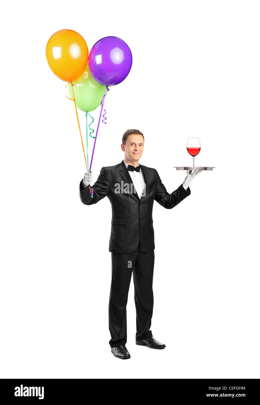 Full length portrait of a butler with bow tie carrying a tray with a ...