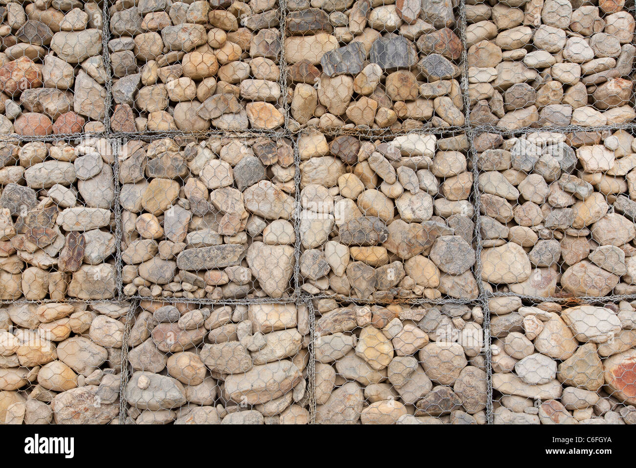Crate filled with pebbles used as wall Stock Photo - Alamy