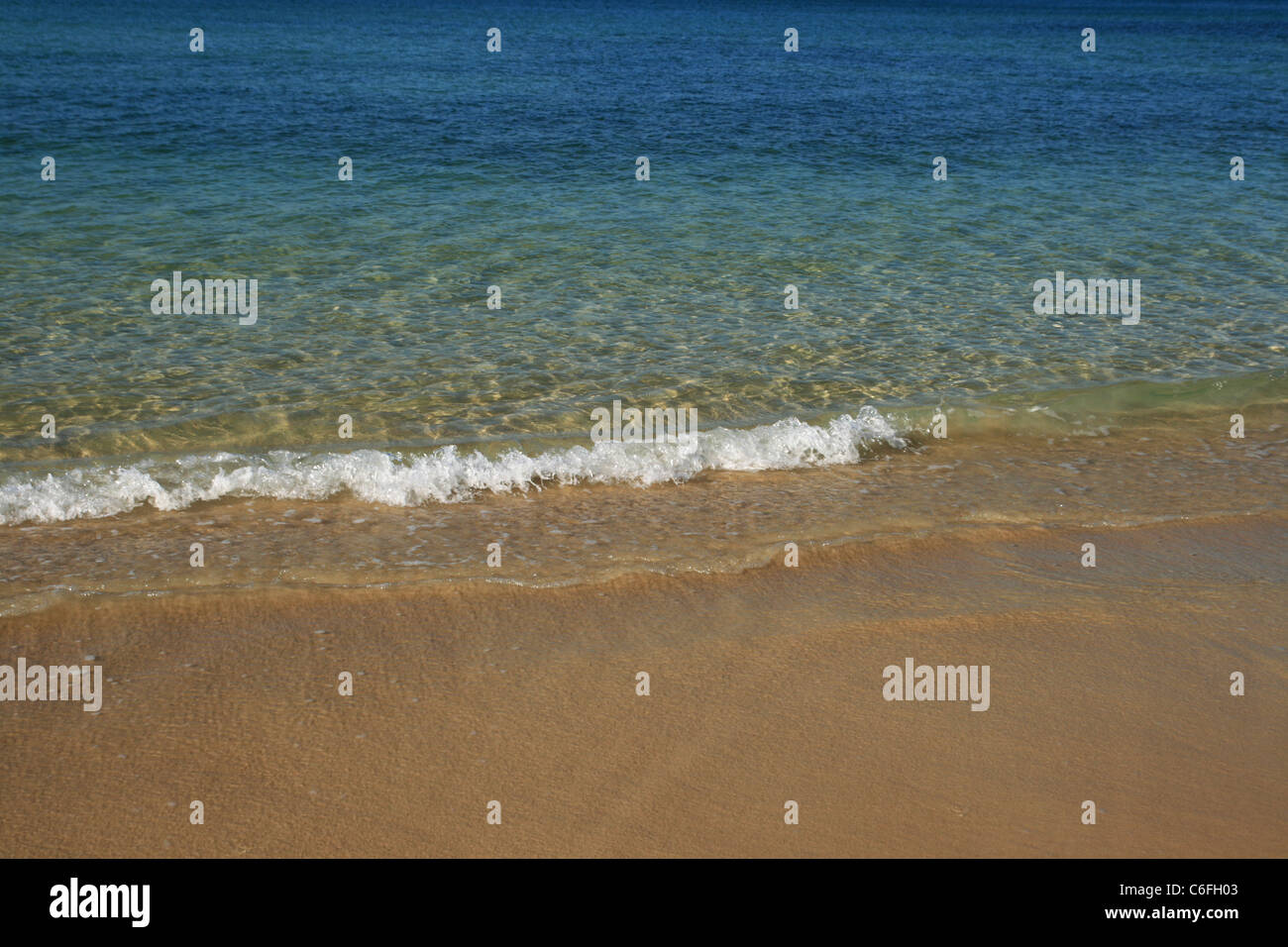 Small wave on a sandy tropical beach in Thailand Stock Photo - Alamy