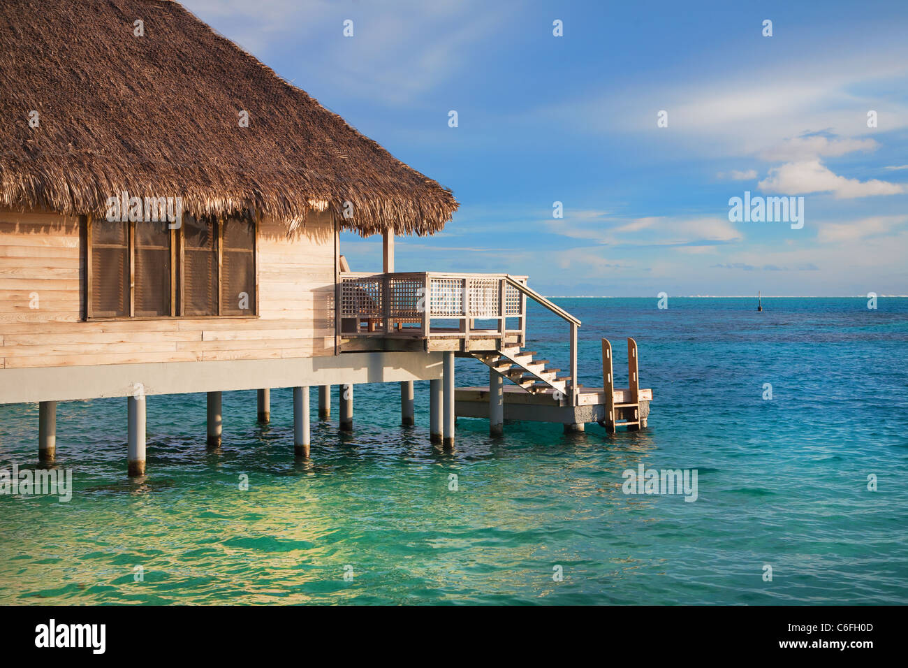 Tropical hut with straw roof on poles in the sea Stock Photo - Alamy