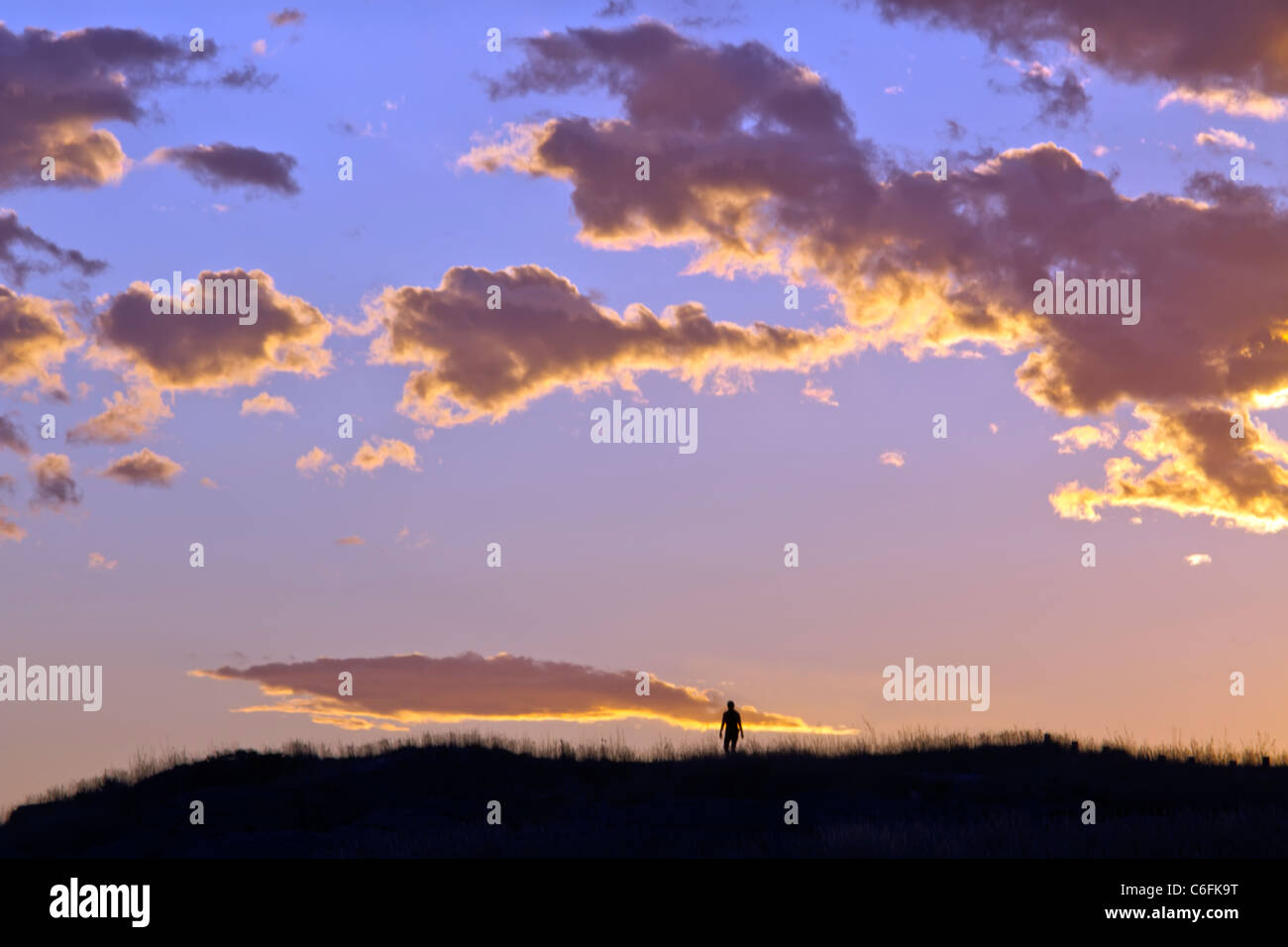 man standing on top of hill contemplating sunset near Billings, Montana ...