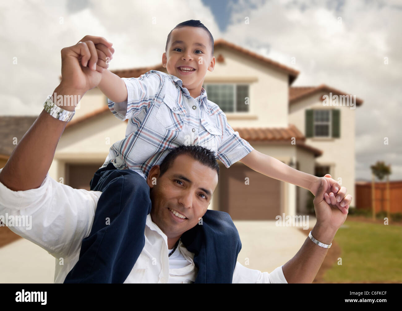 Playful Hispanic Father and Son in Front of Beautiful House Stock Photo ...