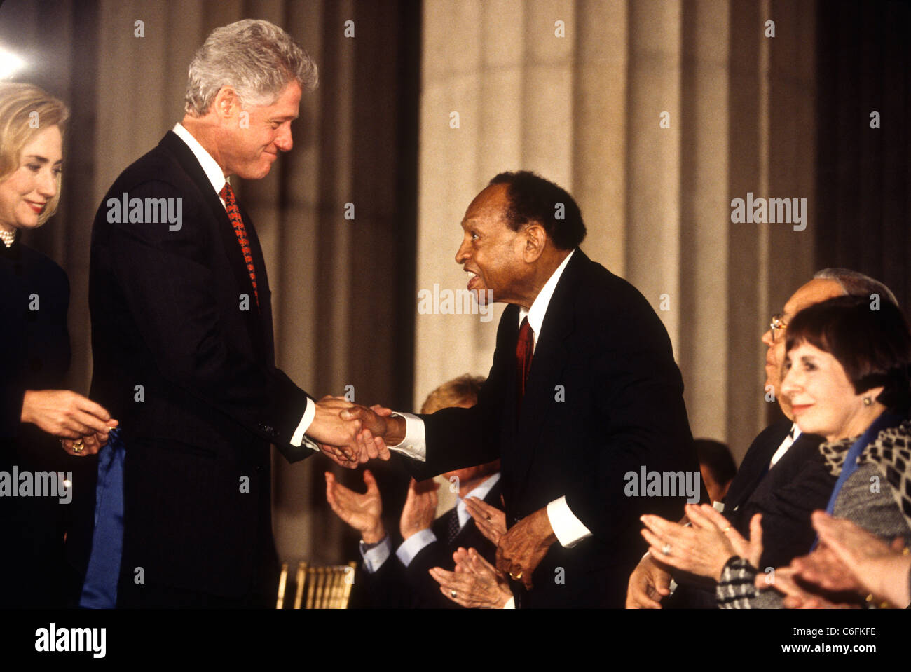 President Bill Clinton shakes hands with jazz legend Lionel Hampton ...