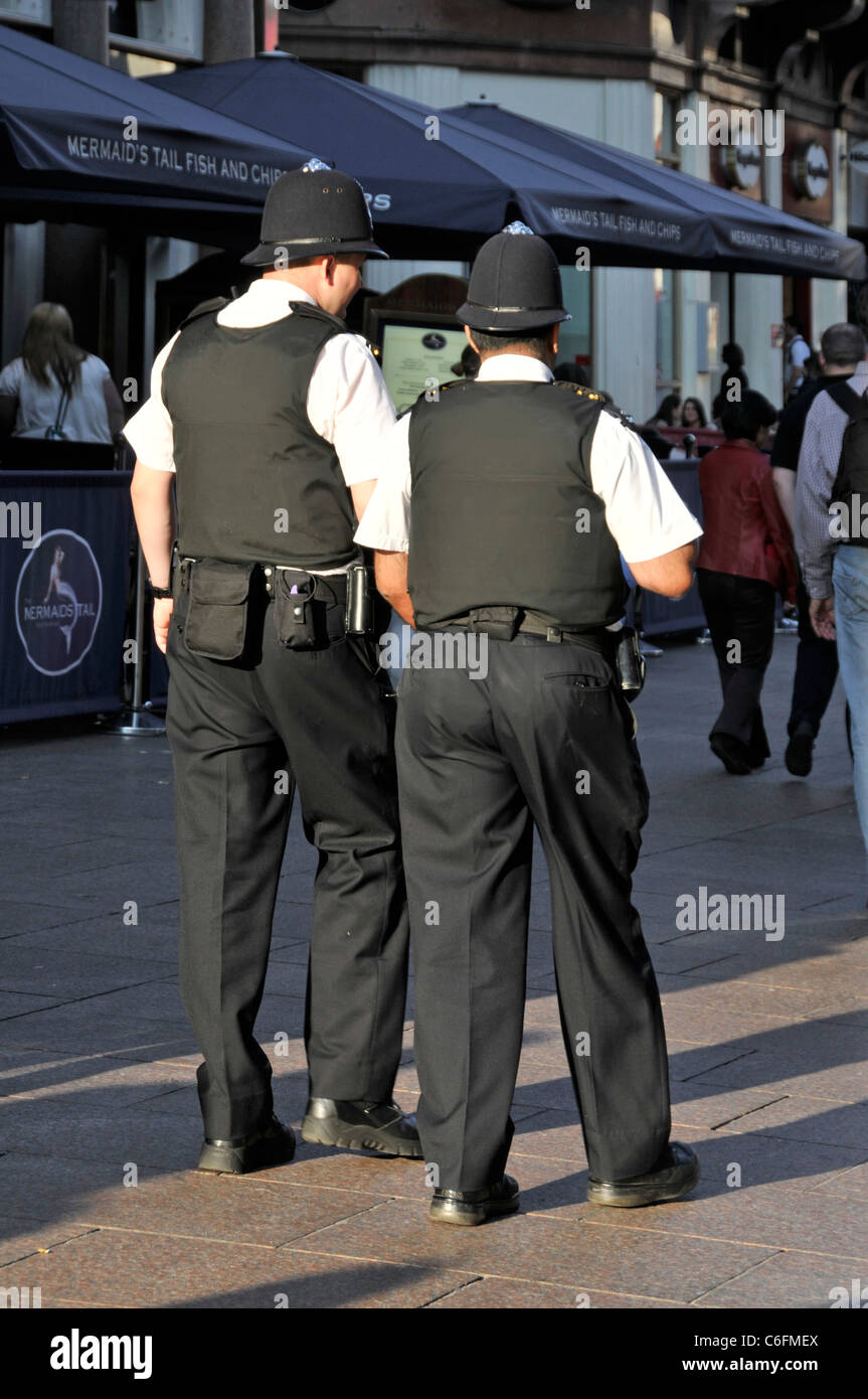 London street scene back view of two Metropolitan Police officers in ...
