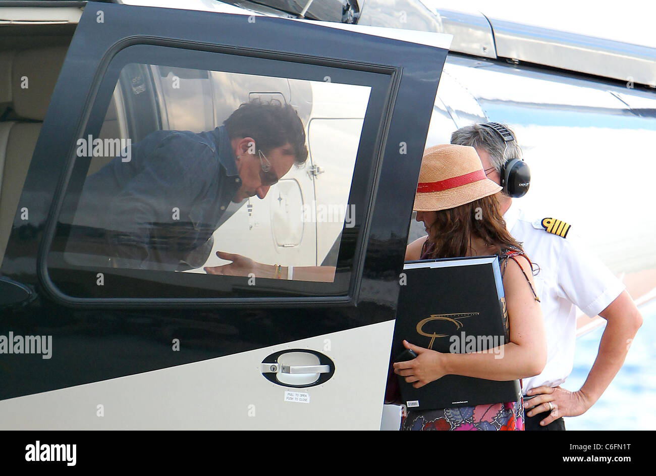 Singer Bono of U2, arriving to Monaco airport by helicopter. Bono is ...