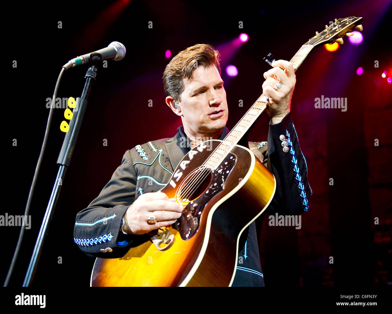 Singer Chris Isaak performing on stage during a concert Shepherds Bush ...