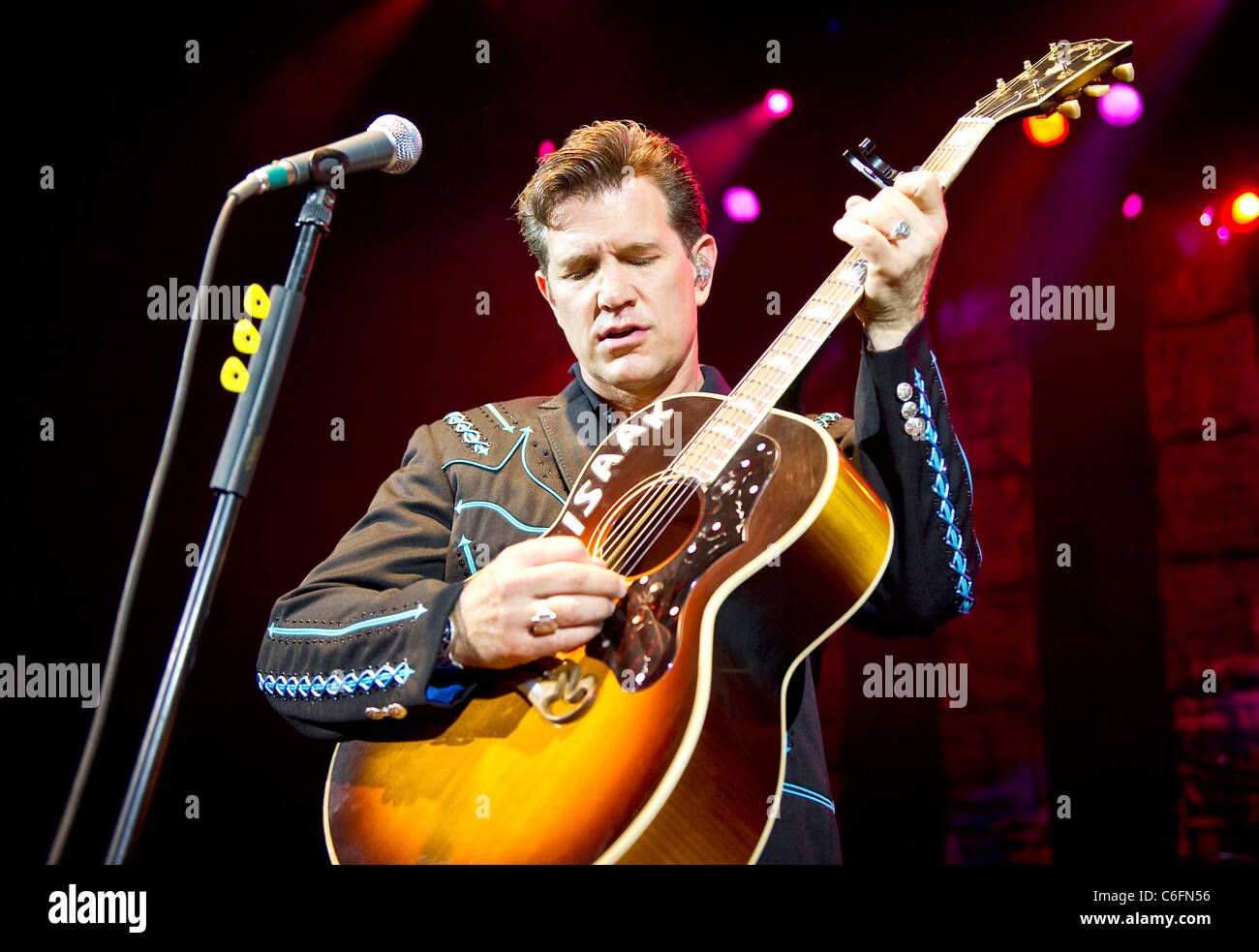 Singer Chris Isaak performing on stage during a concert Shepherds Bush ...