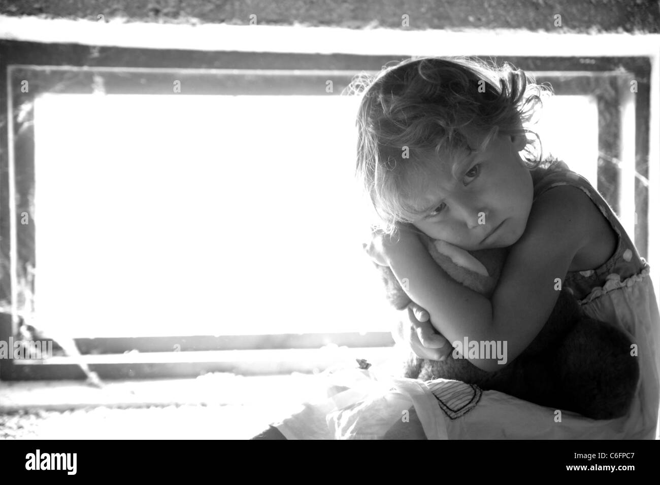 scared girl hugs a teddy bear Stock Photo - Alamy