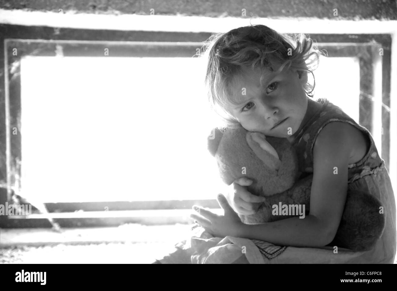 scared girl hugs a teddy bear Stock Photo - Alamy