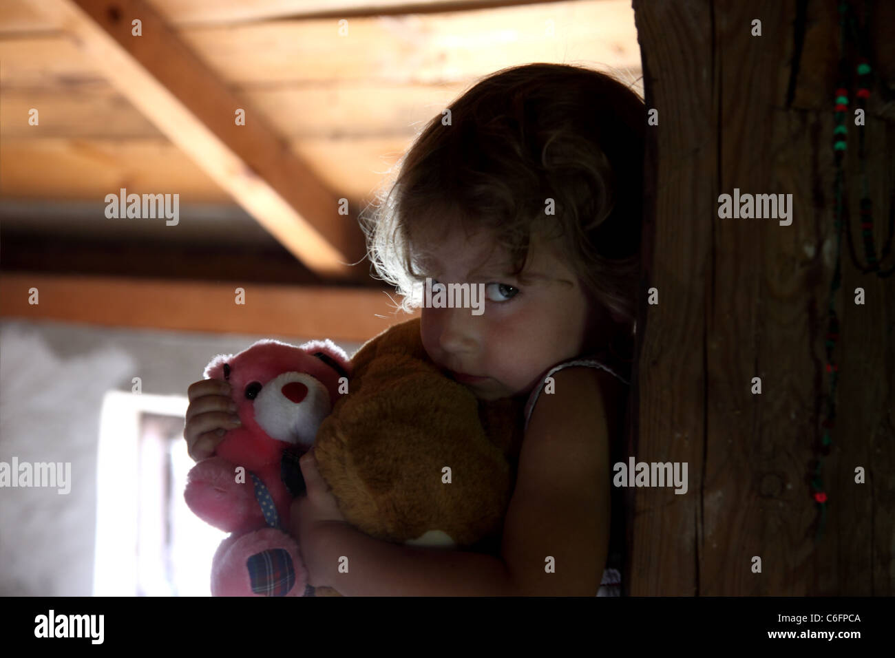 scared girl hugs a teddy bear Stock Photo - Alamy