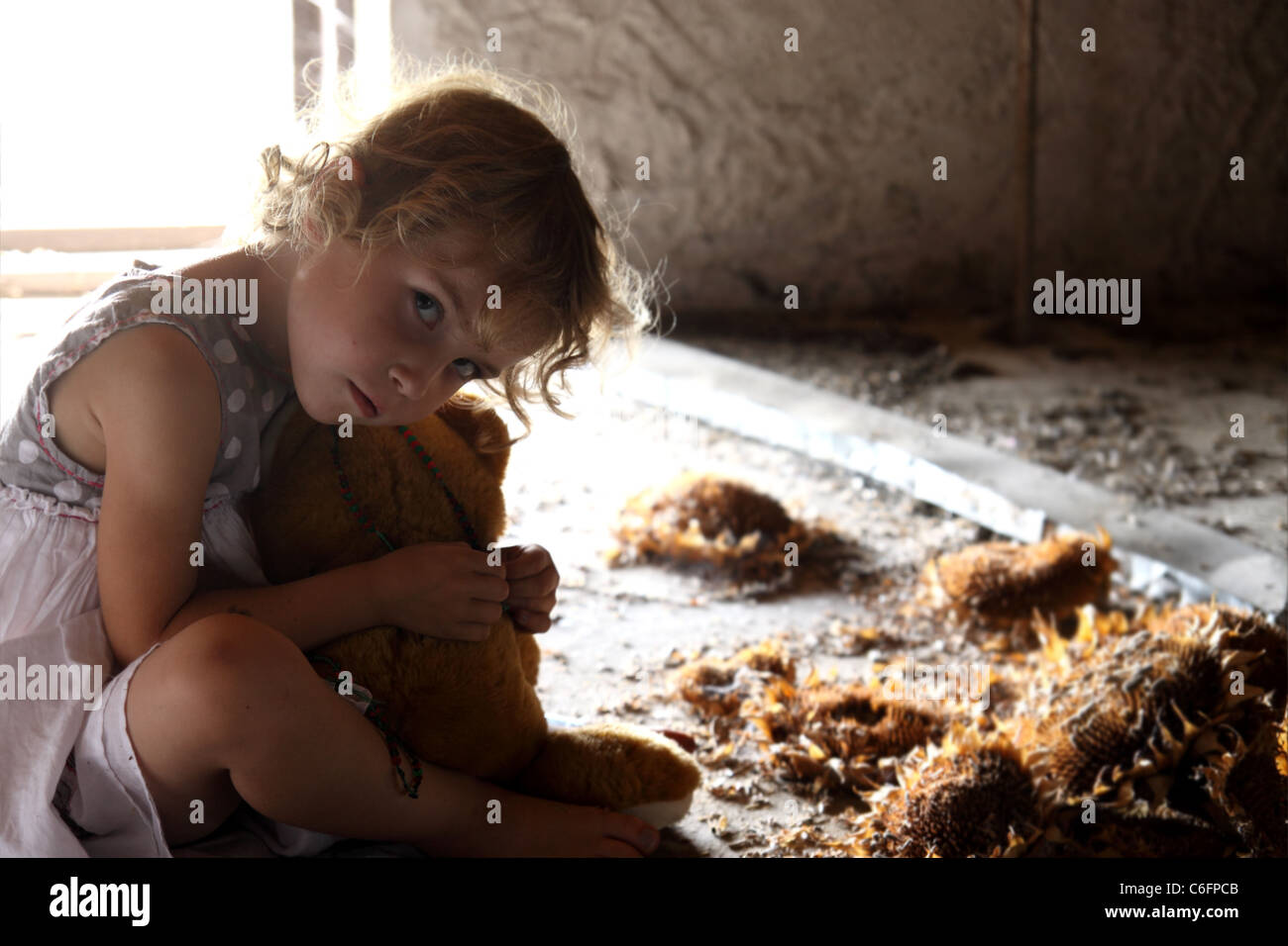 scared girl hugs a teddy bear Stock Photo - Alamy